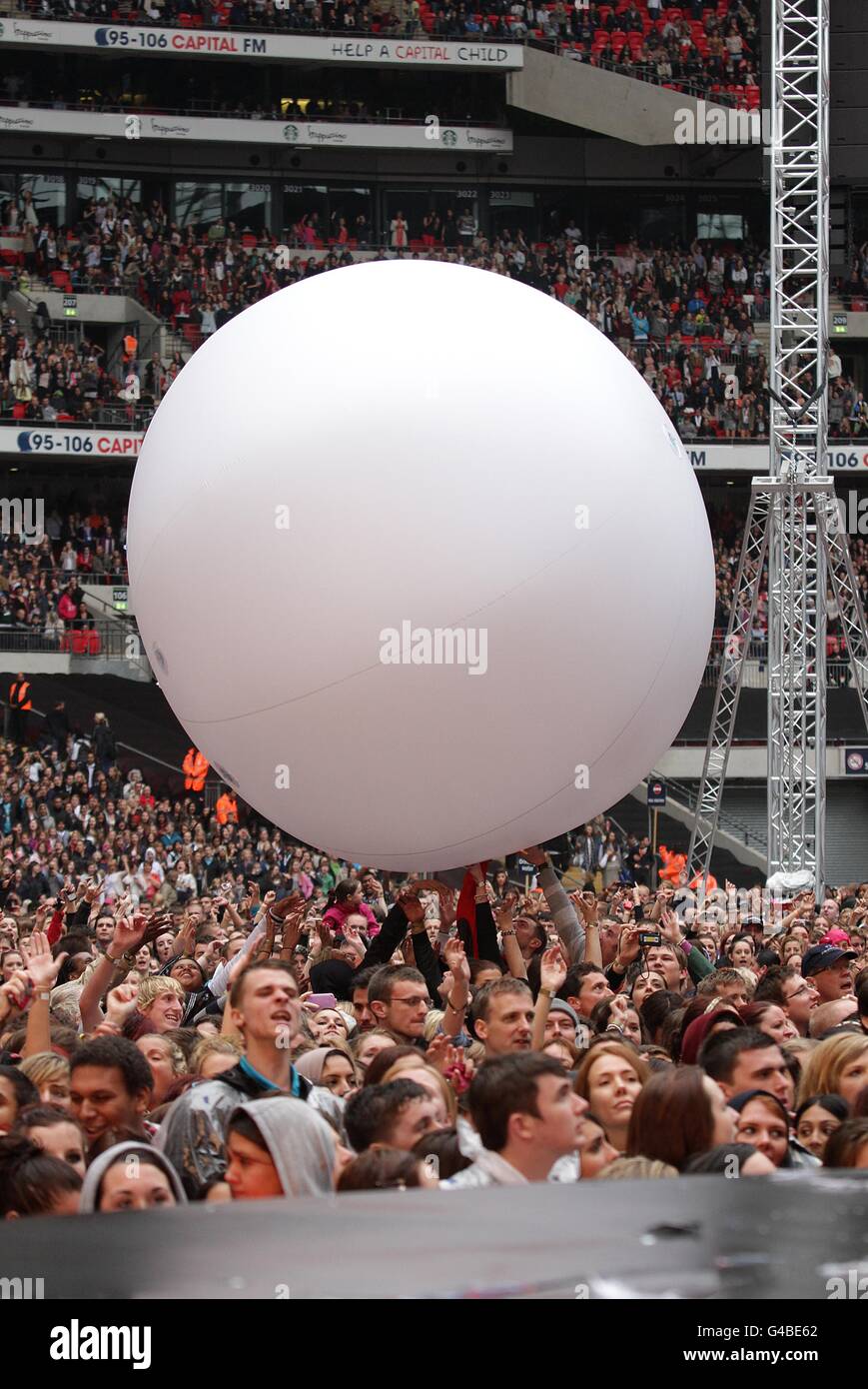 Giant inflatable balls are passed around the crowd during Capital FM's ...