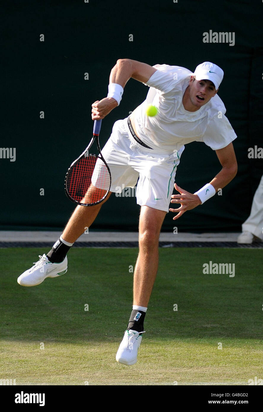 USA's John Isner in action with France's Nicolas Mahut during day two ...