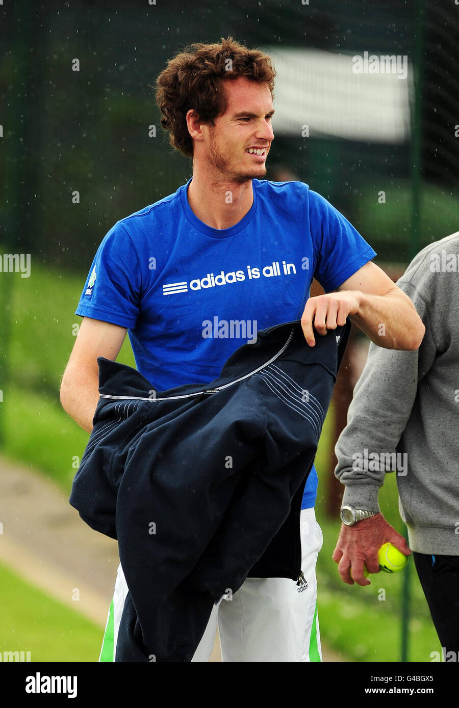 Great Britain's Andy Murray leaves the practice courts as rain starts ...