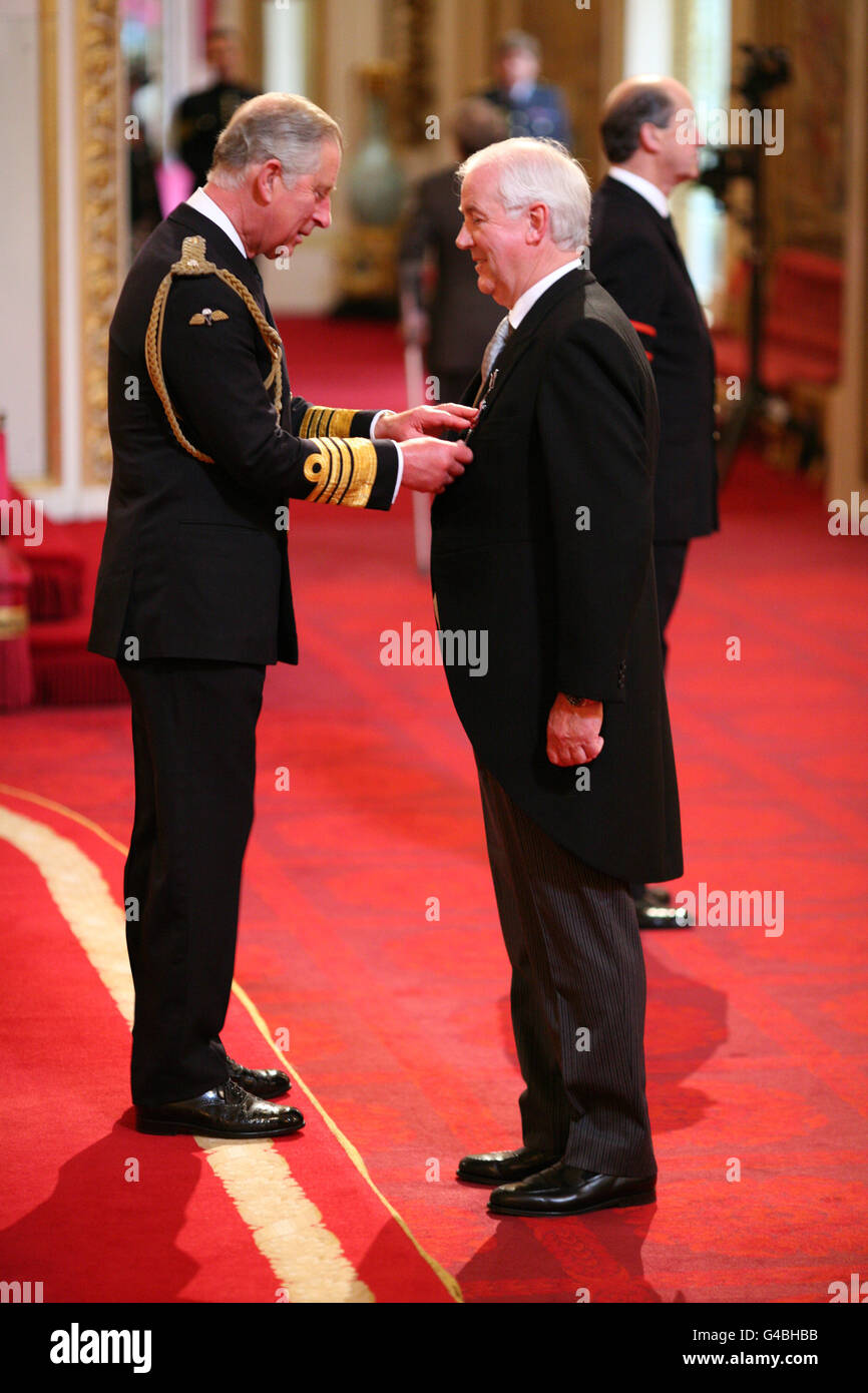 John Moore is presented with his MBE by the Prince of Wales, at the ...