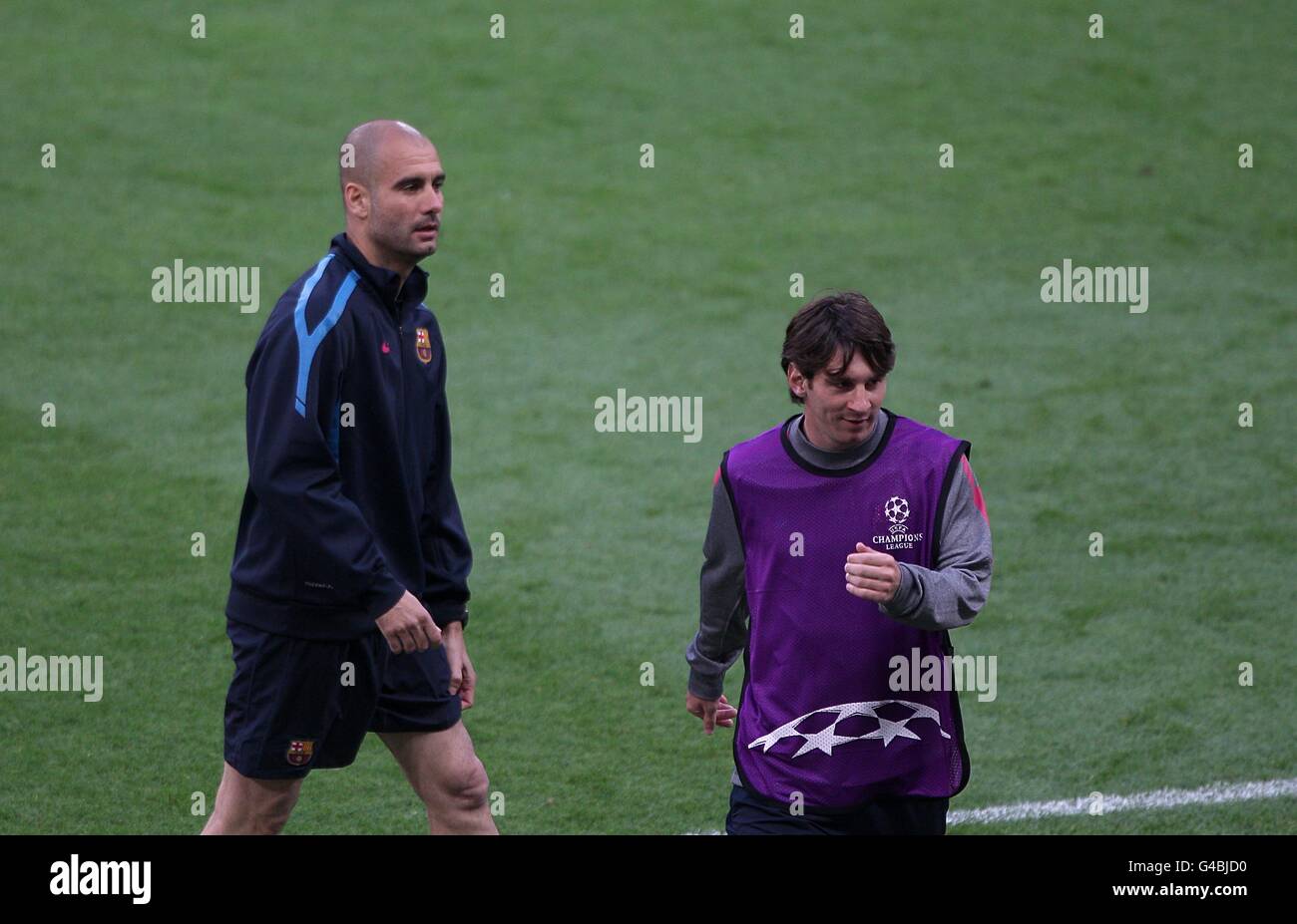 Barcelona manager pep guardiola left and lionel messi in training hi ...