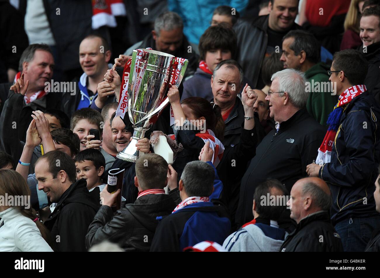 Stevenage fans in the stands get to celebrate with the trophy after the ...