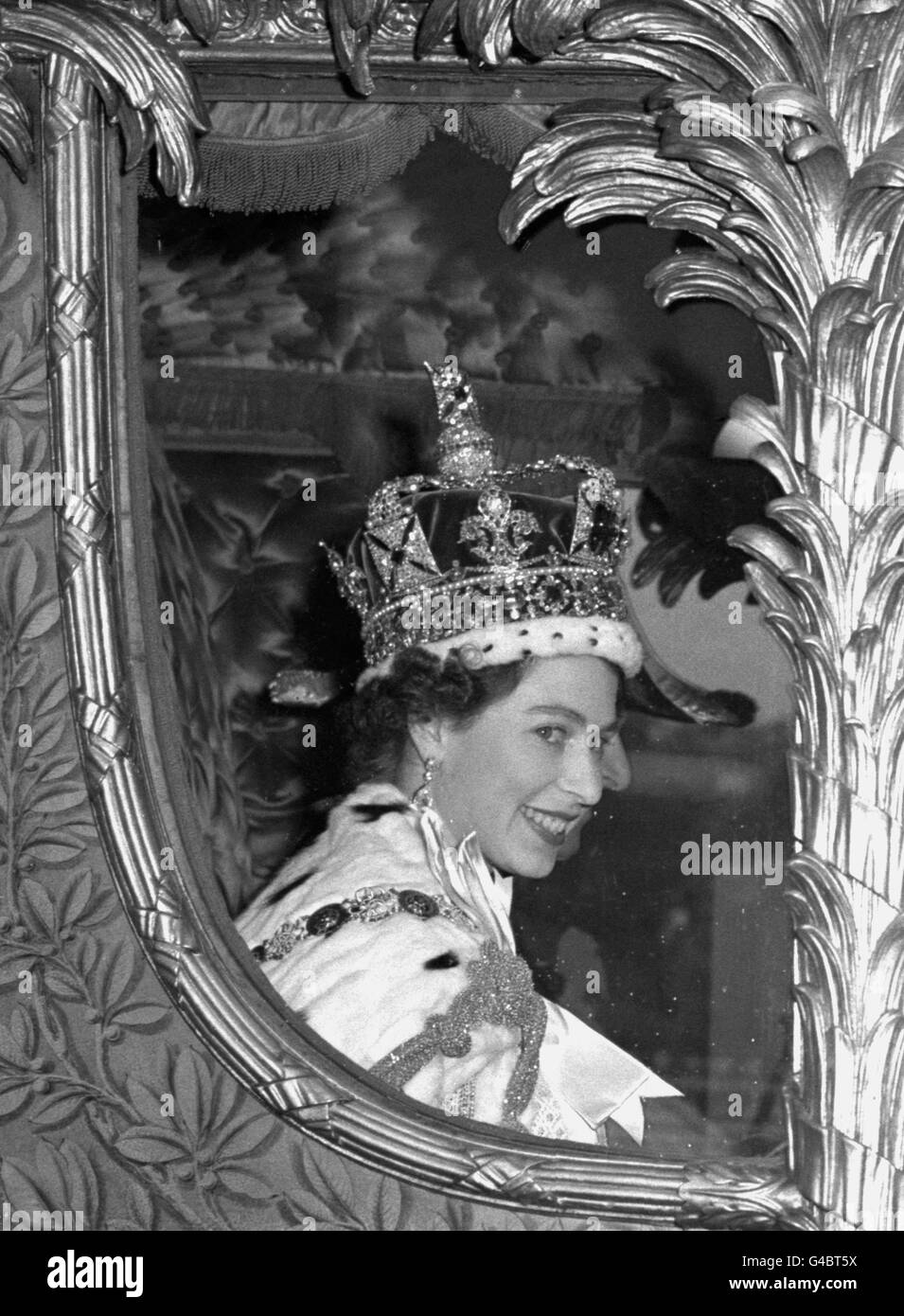 Queen Elizabeth II gives a wide smile for the crowd from her carriage ...