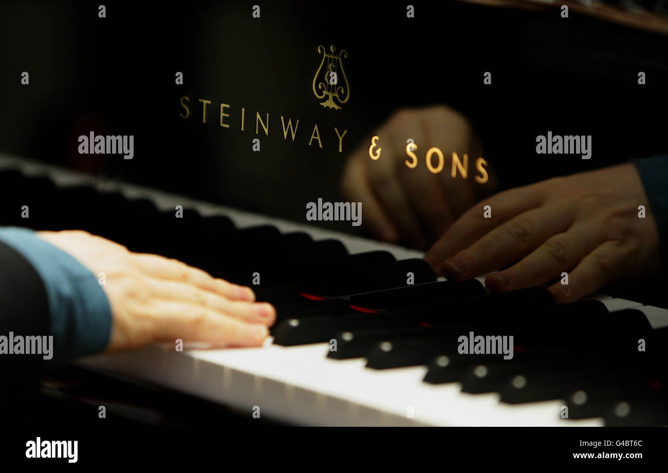 A musician plays the piano as members of the BBC Philharmonic Orchestra ...