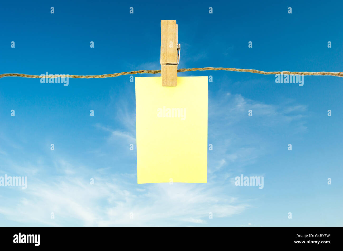 paper notes hanging on rope and sky background Stock Photo - Alamy