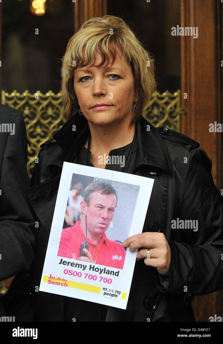 Jacqui Hoyland, wife of missing Jeremy Hoyland, holds up poster of her ...