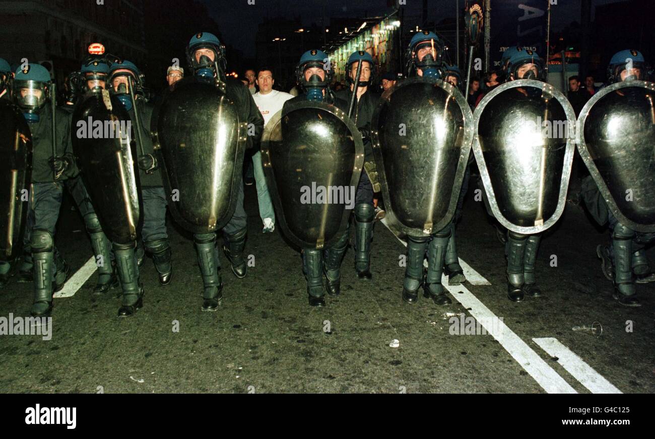 A line of French policemen wearing full riot gear march through the ...