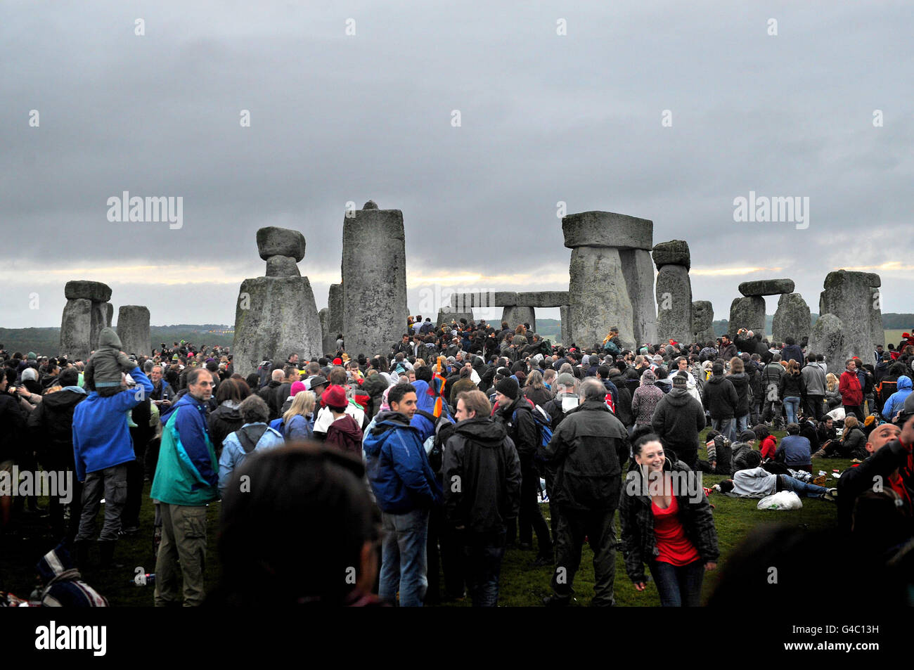 Summer solstice at Stonehenge. Revellers watch the sunrise of the ...
