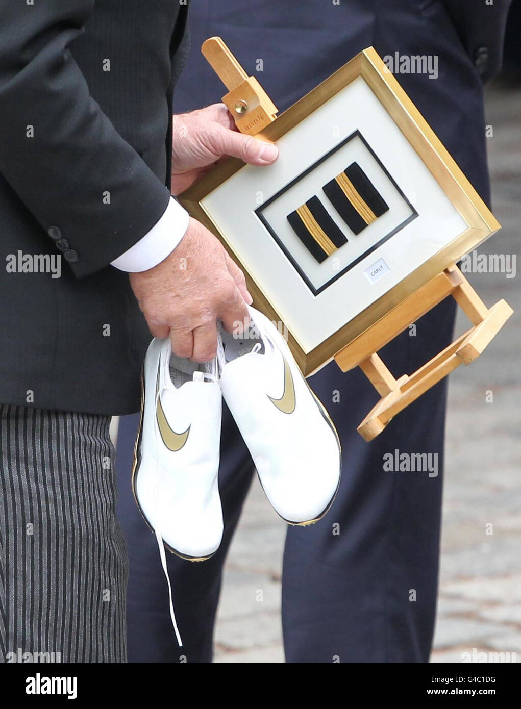 Running shoes and a picture frame is carried into the crematorium for ...