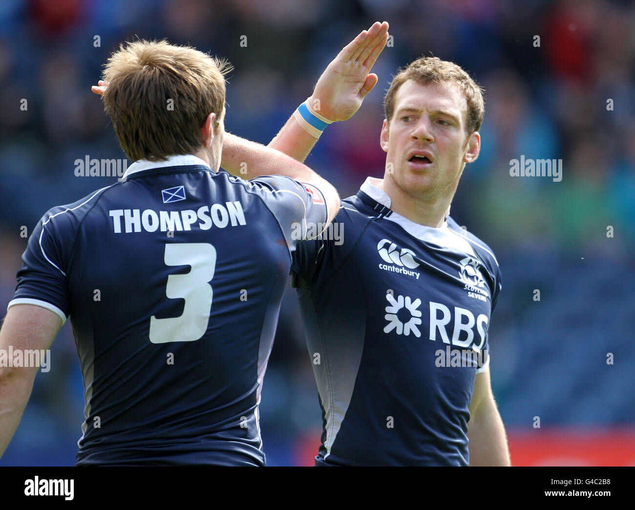 Scotland's Jim Thompson celebrates a try with Scott Riddell (right ...