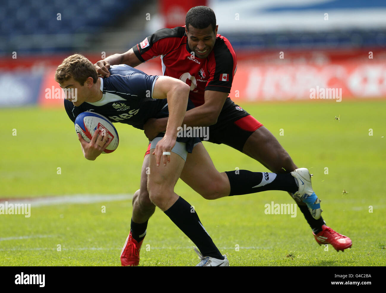Scotland's Michael Fedo is challenged by Canada's Justin-Mensah-Coker ...