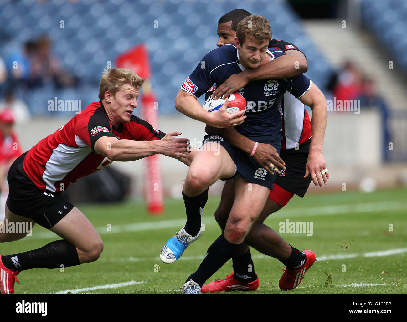 Scotland's Michael Fedo is tackled by Canada's Justin-Mensah-Coker and ...