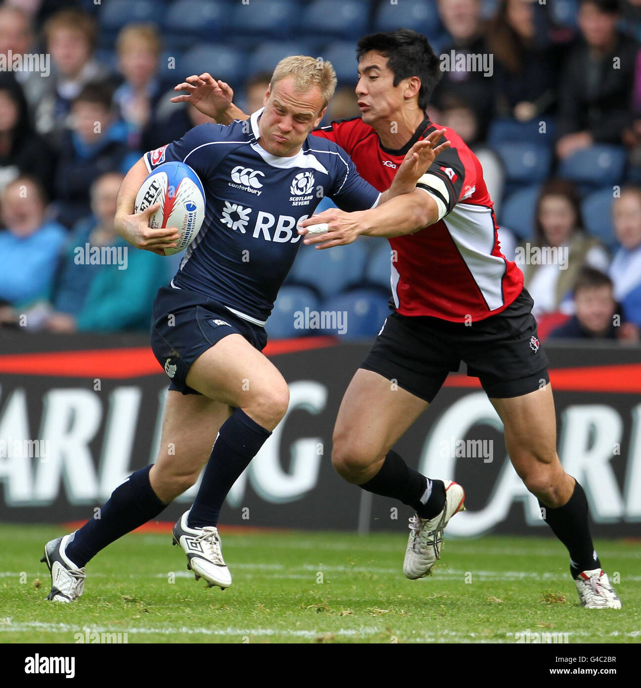 Scotland's Andrew Turnbull is challenged by Canada's Sean Duke during ...