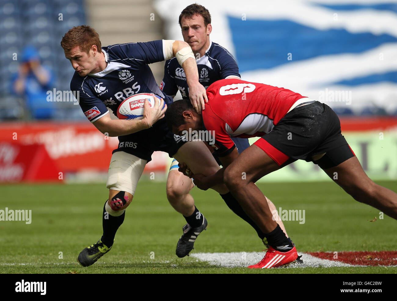 Scotland's Michael Fedo is challenged by Canada's Justin-Mensah-Coker ...