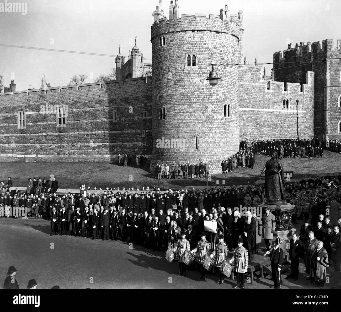 Overlooked by a statue of Queen Victoria and the ramparts of Windsor ...