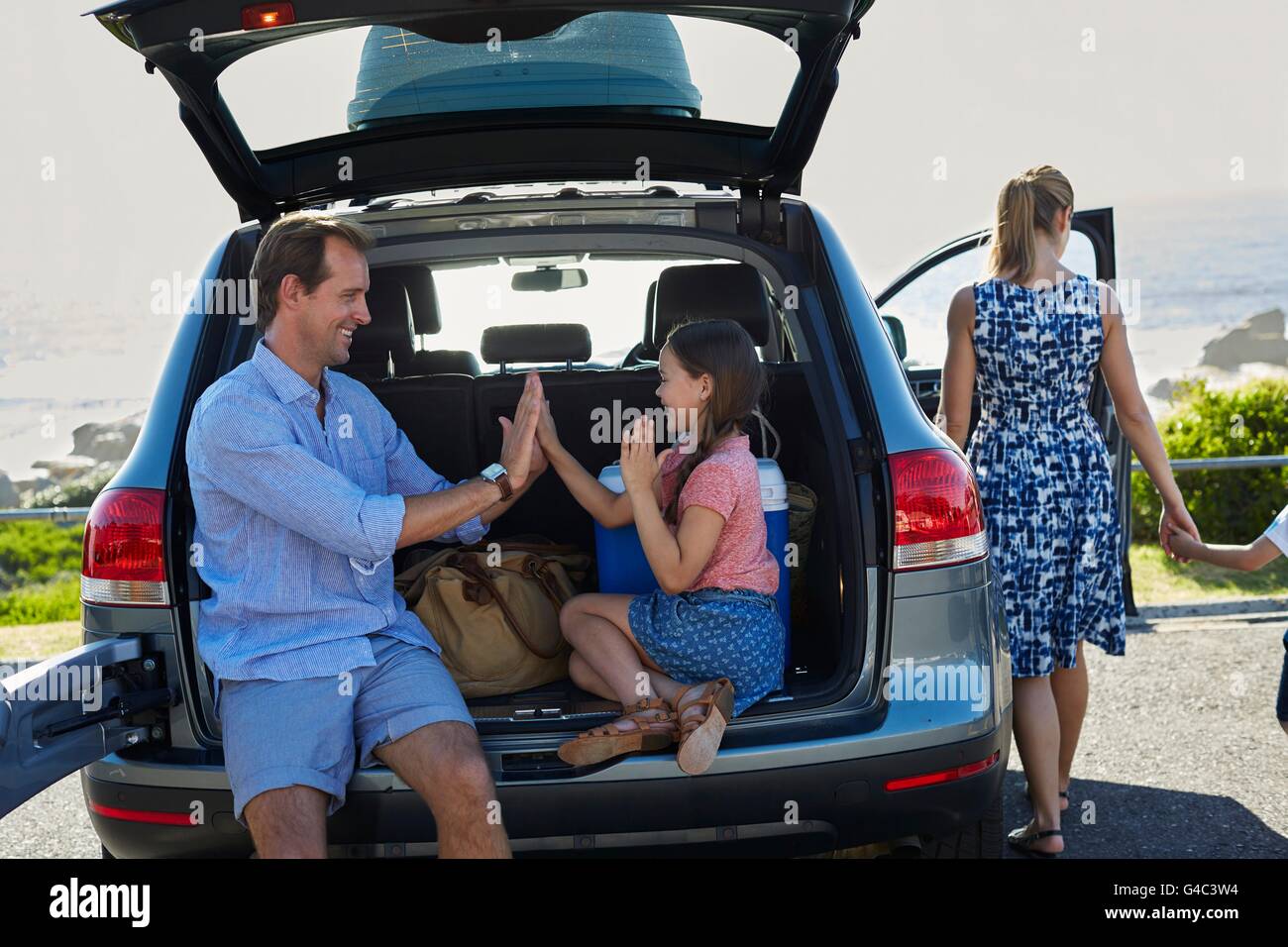 MODEL RELEASED. Father playing pat-a-cake with daughter in the car ...