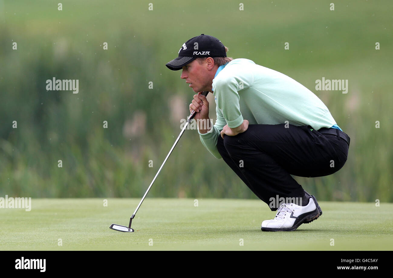 Sweden's Alexander Noren lines up his putt on the 5th green on his way ...