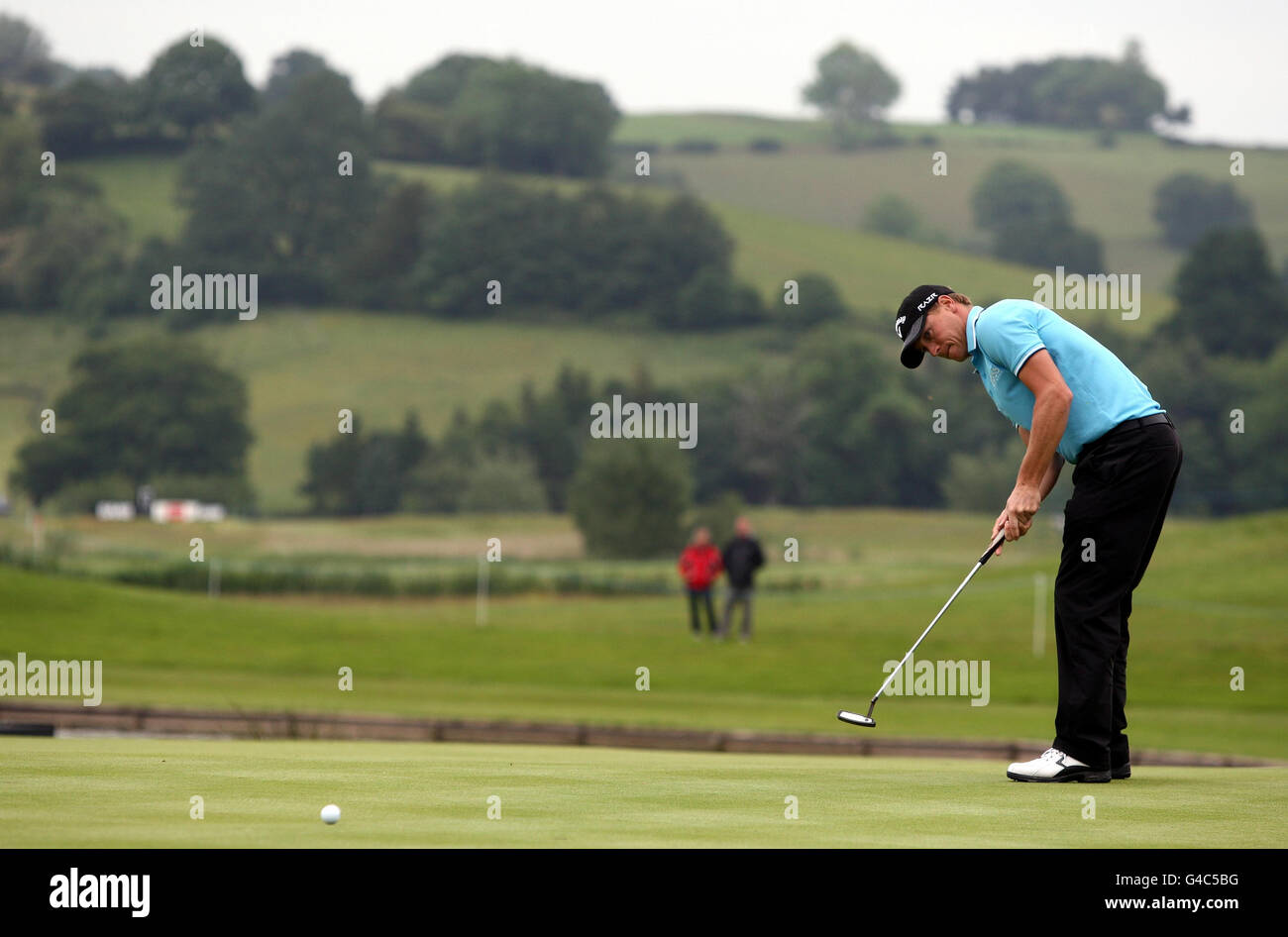 Sweden's Alexander Noren putts on the 13th green on his way to victory ...