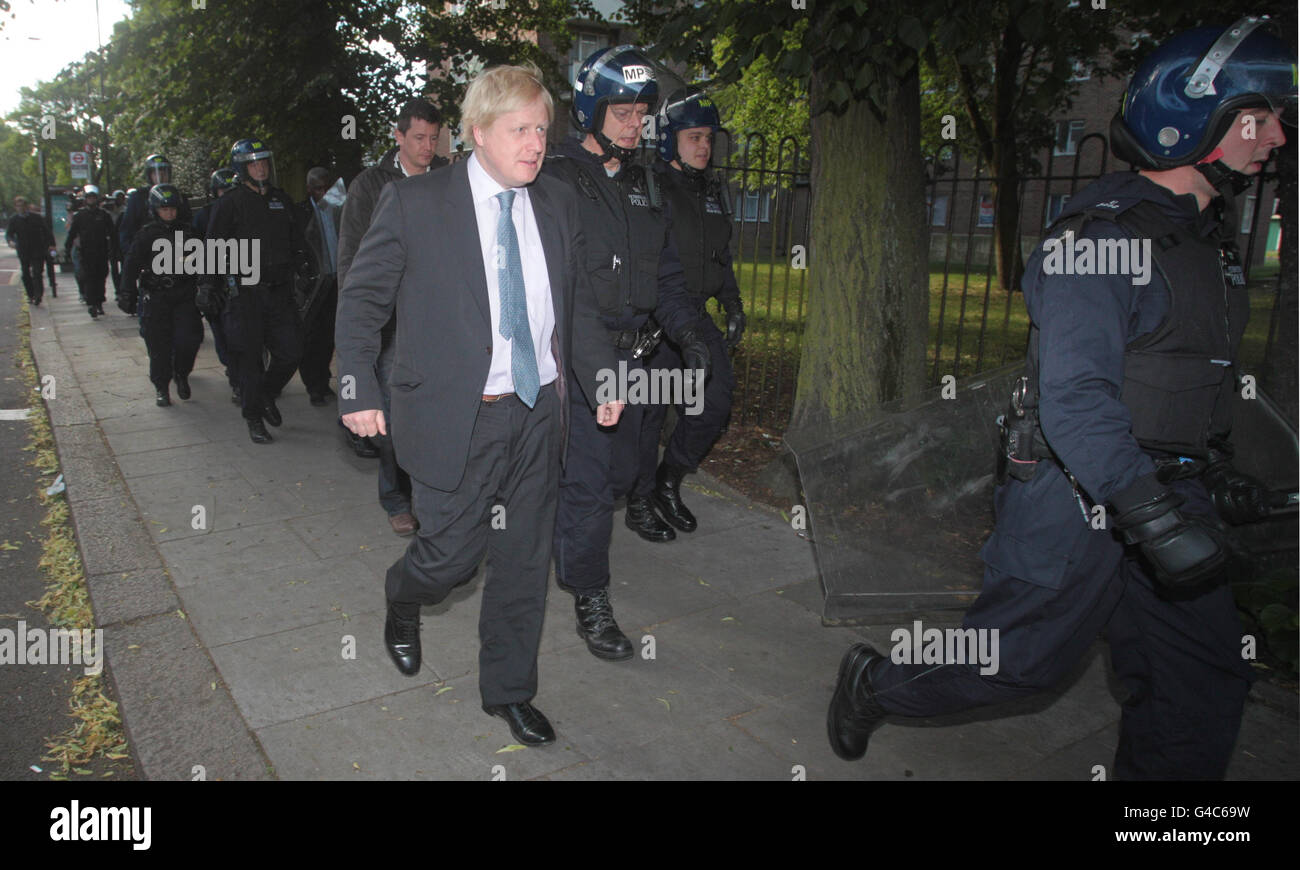 Boris Johnson accompanies police officers during a dawn raid at a ...