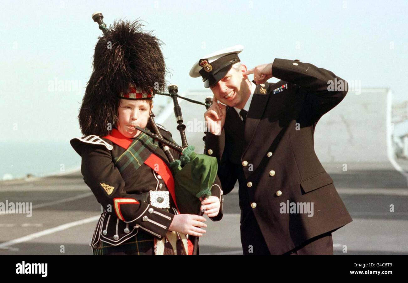 Chief Petty Officer, Jason King, jokingly blocks his ears as his 14 ...