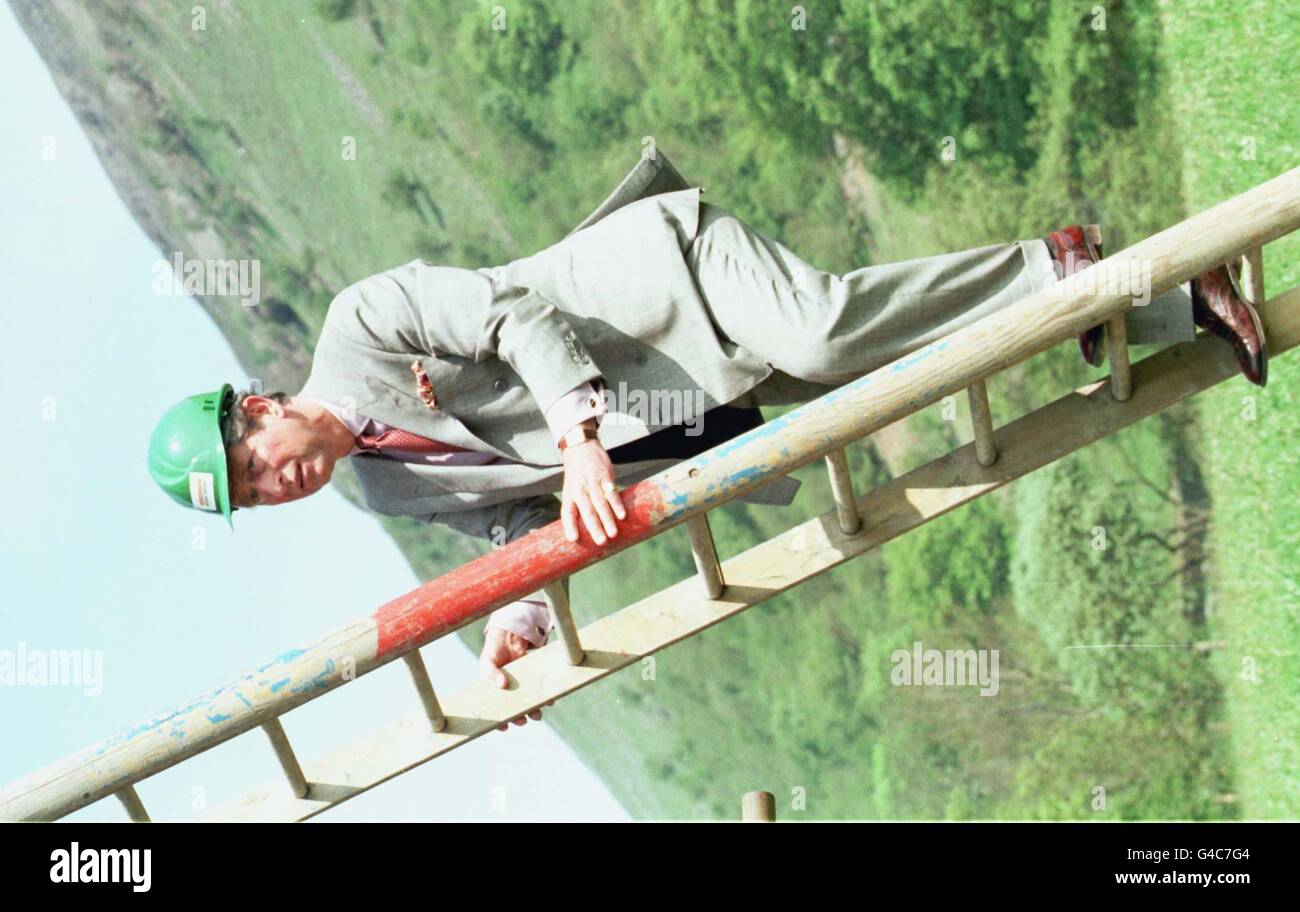 The Prince of Wales climbs a ladder to look at Barn restoration work in ...