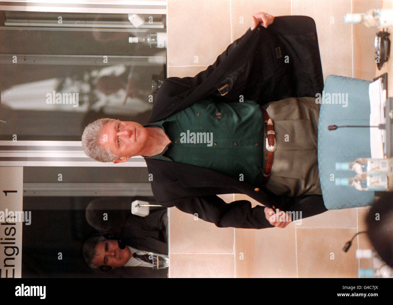 US President Bill Clinton sits down at the talks table of the G8 Summit ...