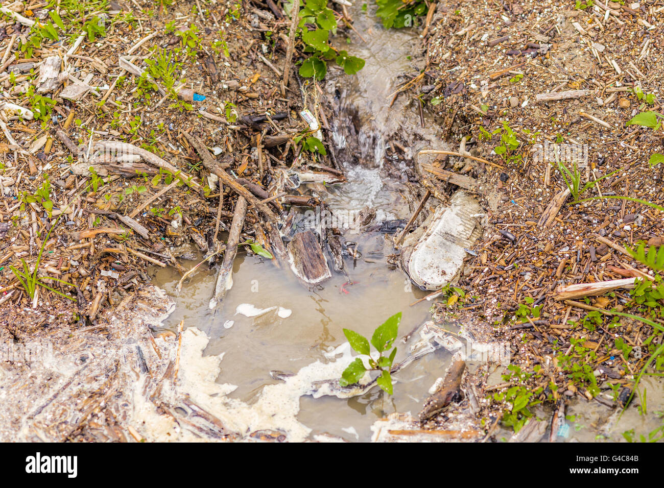 waste and sewage discharge channel with an athletic shoe sole ...