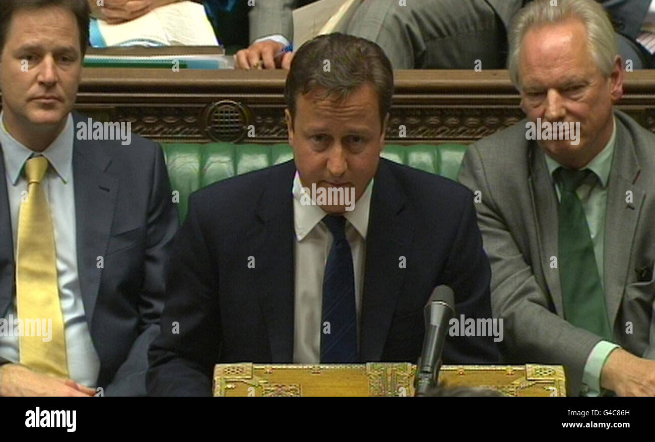 Prime Minister David Cameron (centre) listens to Labour party leader Ed ...