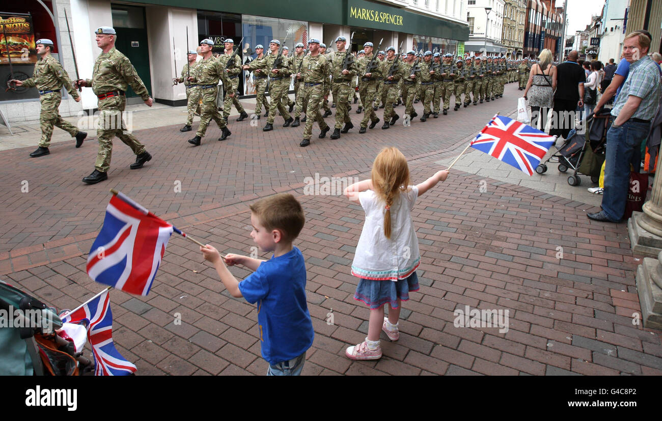 Children wave flags as servicemen and women from 4 Regiment Army Air ...