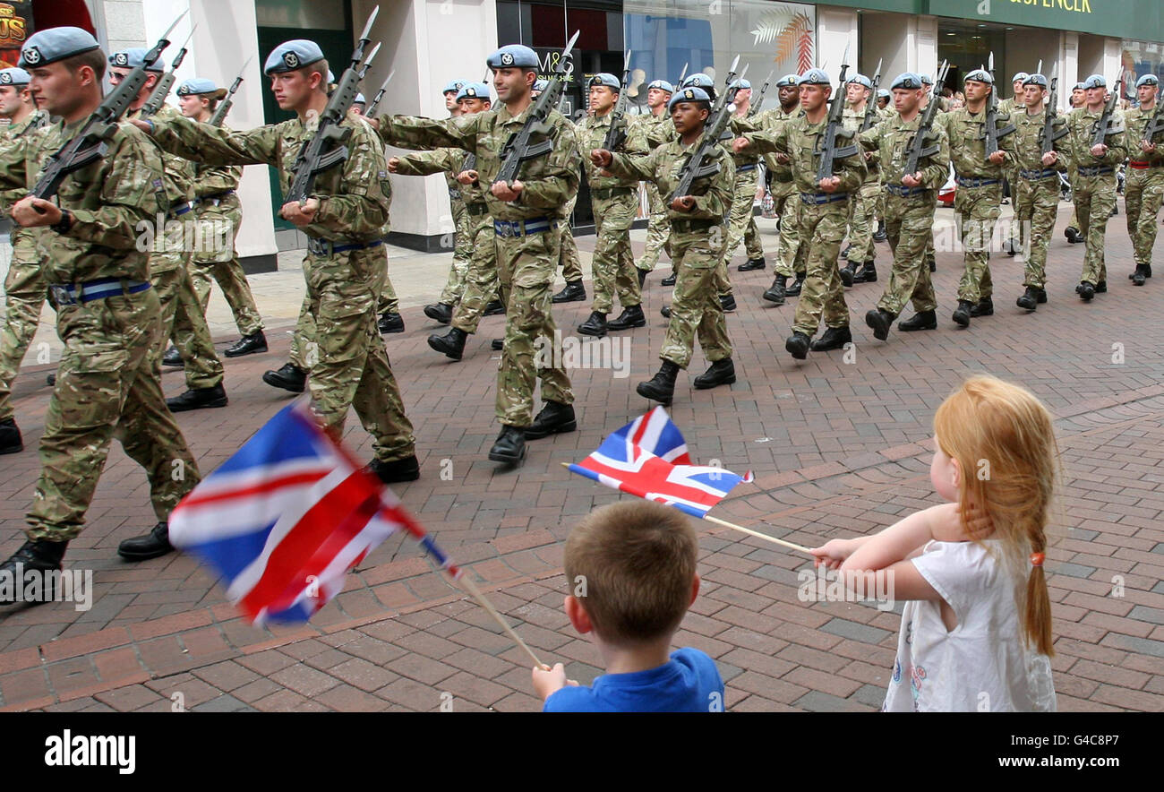 Children wave flags as servicemen and women from 4 Regiment Army Air ...