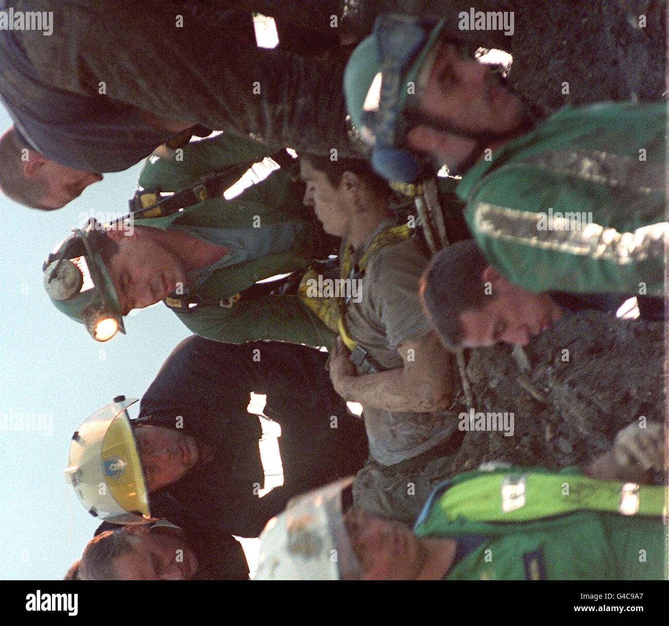 Exhausted rescue workers from the Fire Service, Paramedics and Mines ...