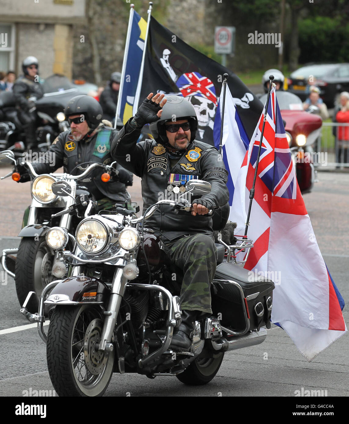 Veterans ride motorcycles down the Royal Mile from the Castle Esplanade ...