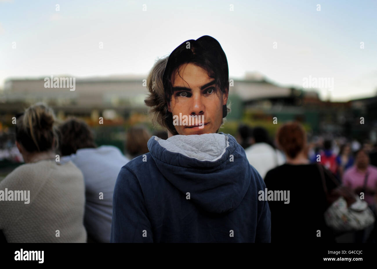 A man wears a Rafael Nadal mask during day six of the 2011 Wimbledon ...