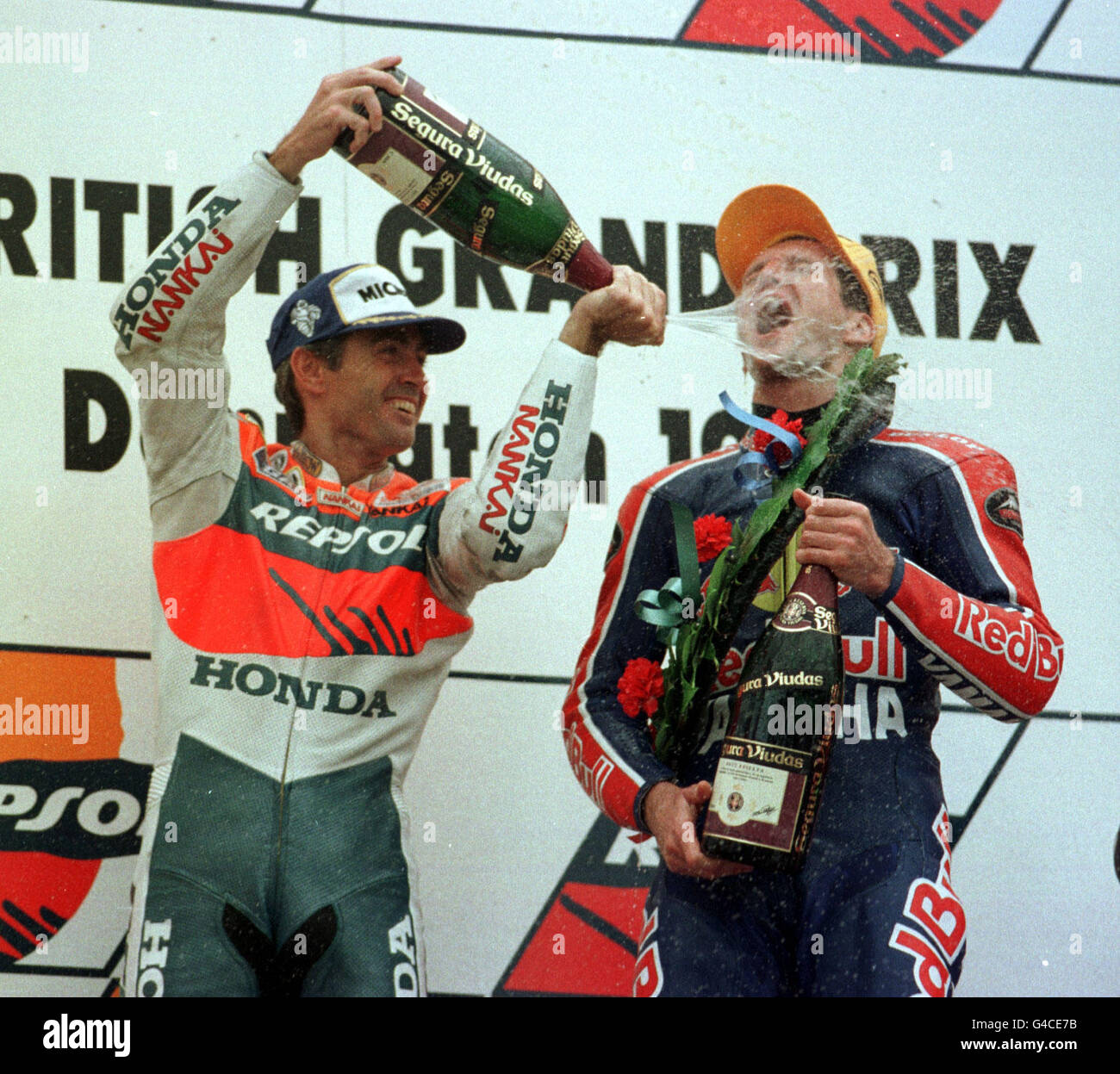 Winner of the 500CC IS NZE, Simon Crafar is showered with champagne by ...
