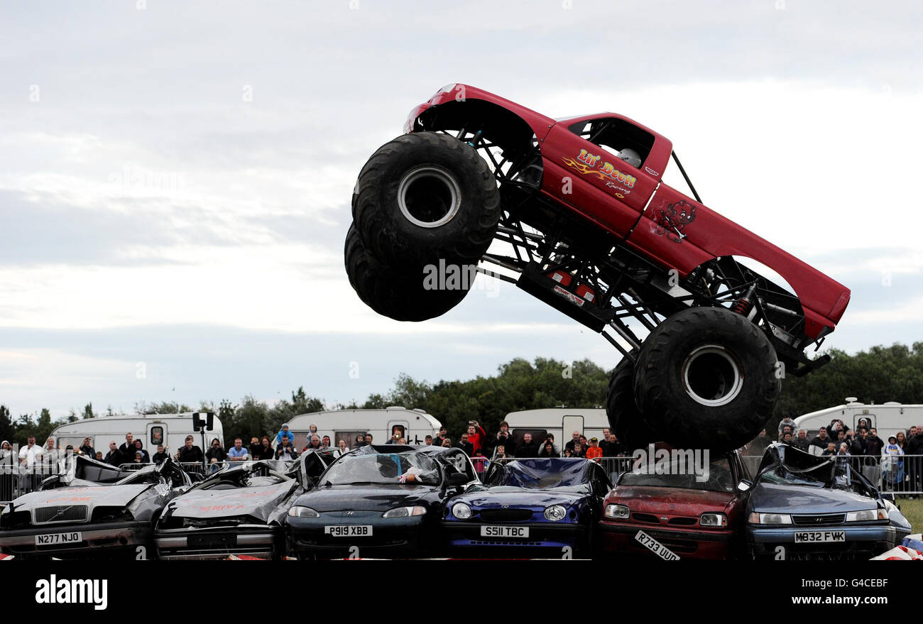 The Monster Truck from The Extreme Stunt Show drives over vehicles at a ...