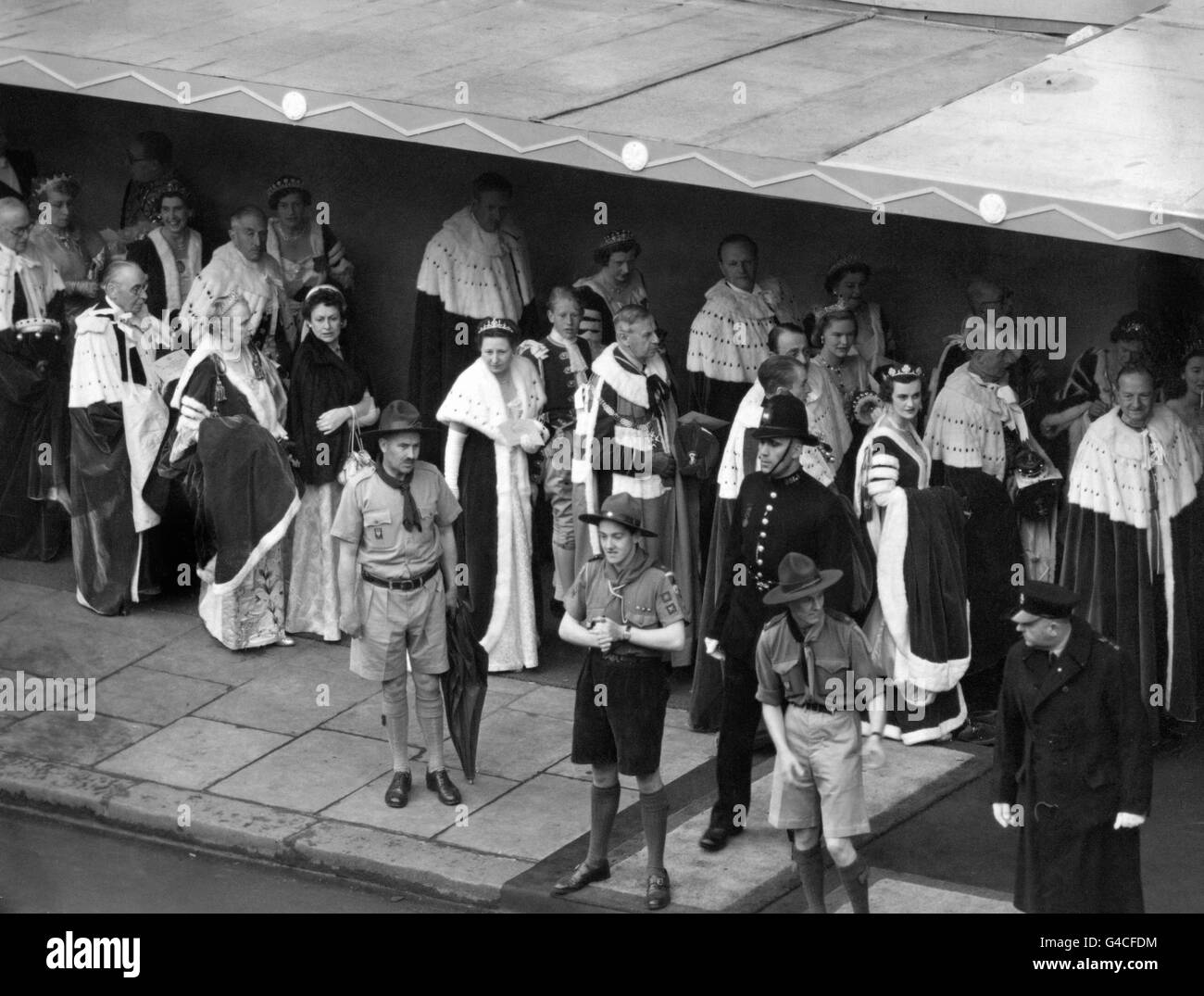 Peers and peeresses in their robes enter Westminster Abbey to take ...