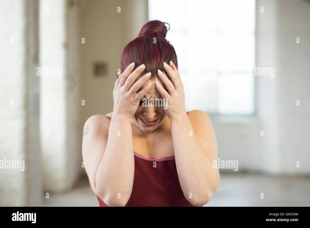 Stressed woman head in hands indoors Stock Photo - Alamy