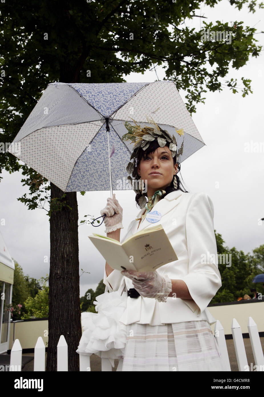 Racegoer Annabelle Fuller reads a race card on day four of the Royal ...