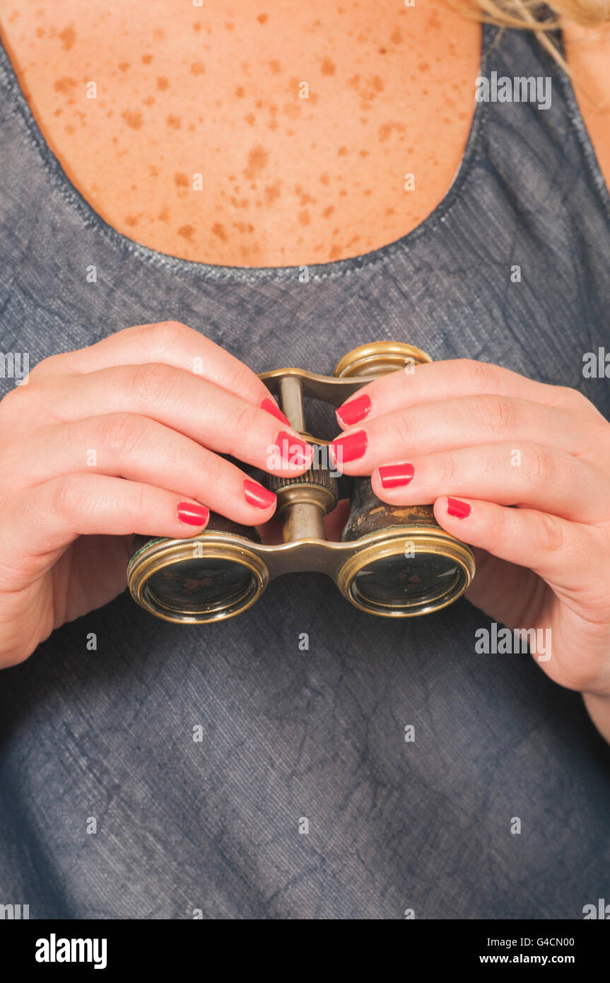 Close up of a woman's hand holding binoculars Stock Photo - Alamy