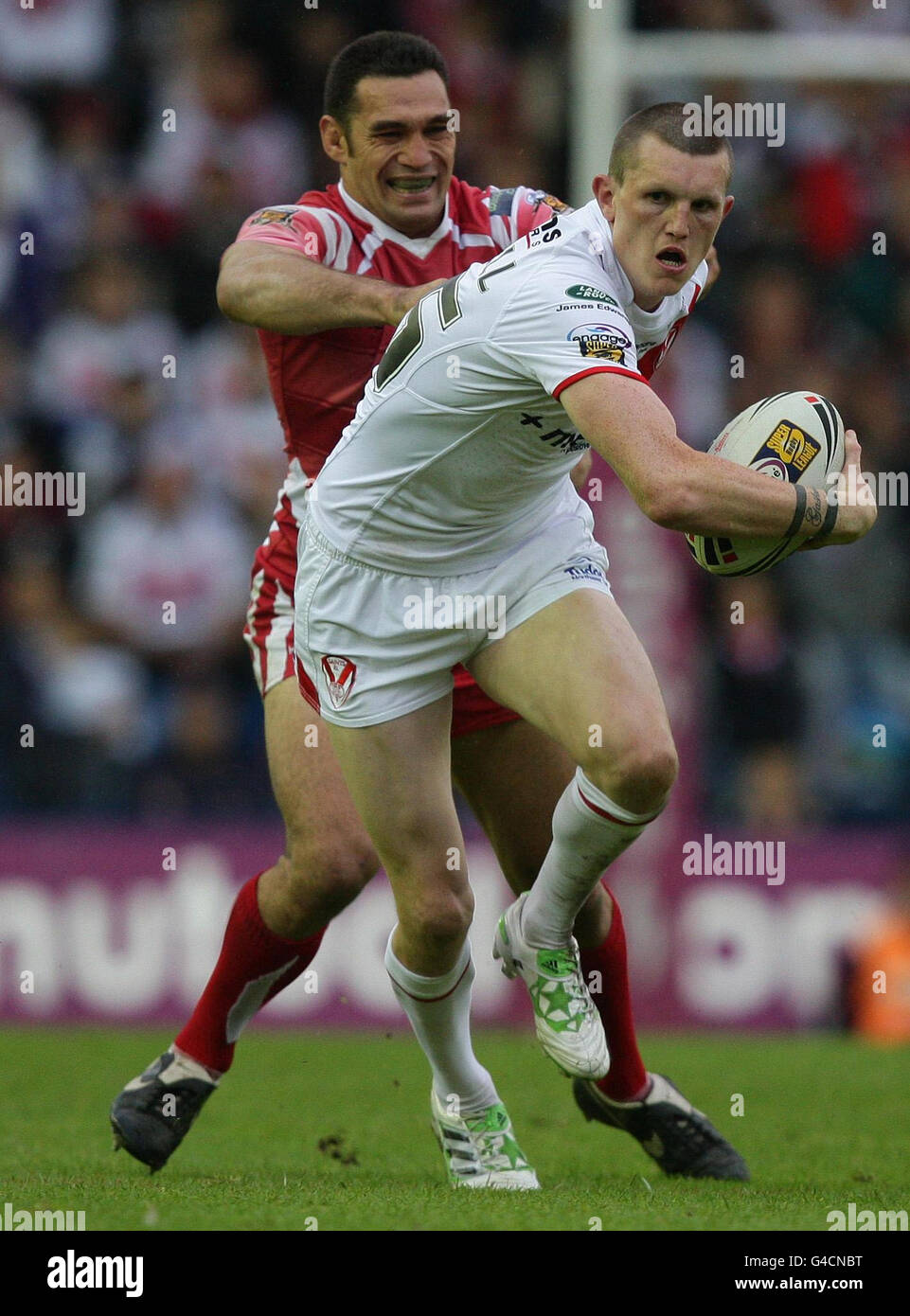 St. Helens' Lee Gaskell breaks away from the Wigan Warriors' defence ...