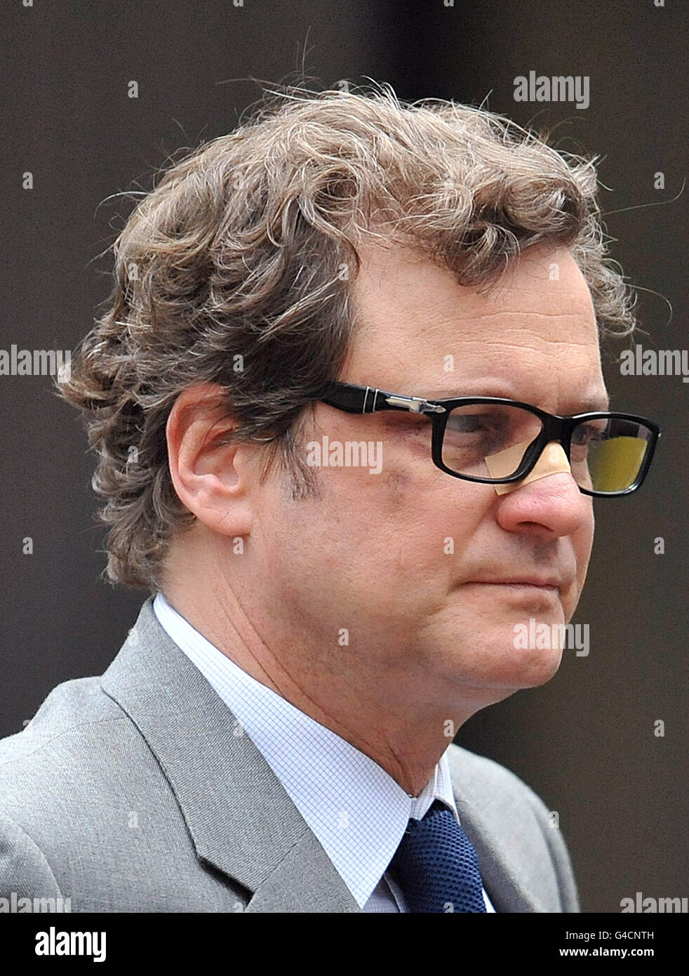 Colin Firth,wears a plaster on his nose, during filming on the set of ...
