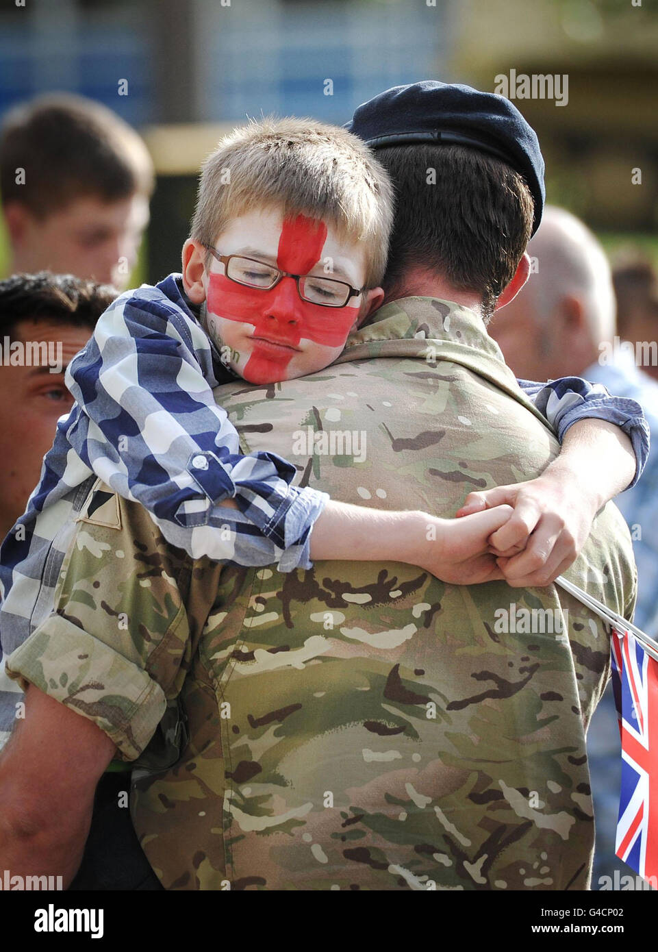Kieran Purvis, aged nine, embraces his father Sargeant Steve Purvis at ...