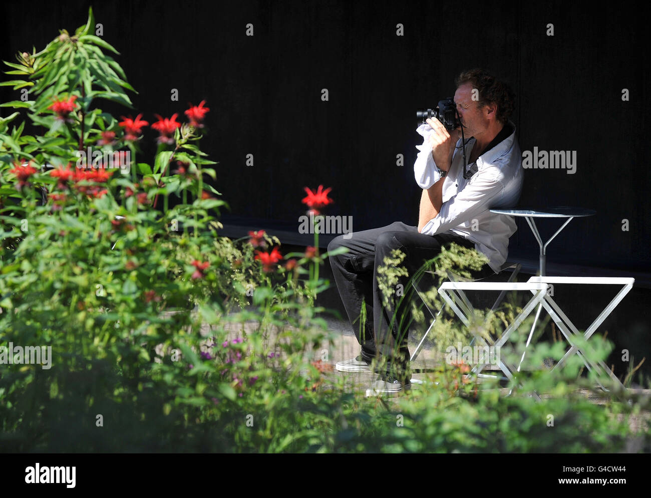 A photographer takes a photo of Dutch landscape designer Piet Oudolf's ...