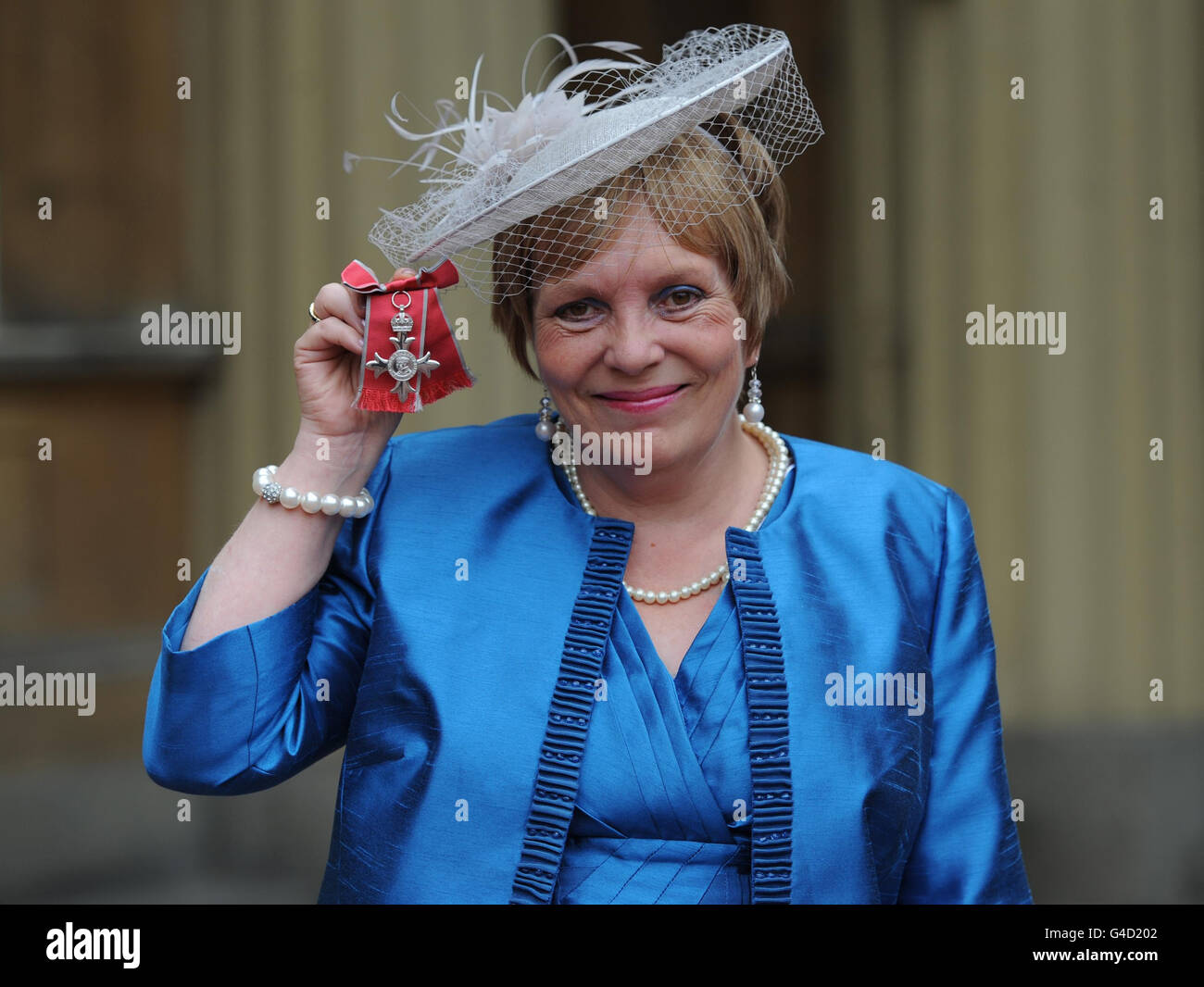 Sue Roberts poses with her MBE which she received from Queen Elizabeth ...