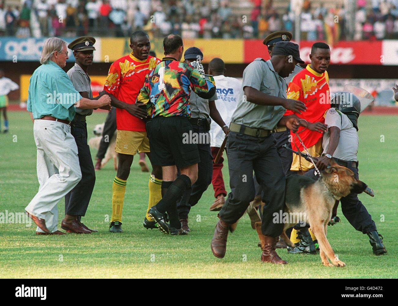 BRUCE GROBBELAAR, ZIMBABWE, RUNS FOR COVER AS THE FANS RUN ONTO THE ...