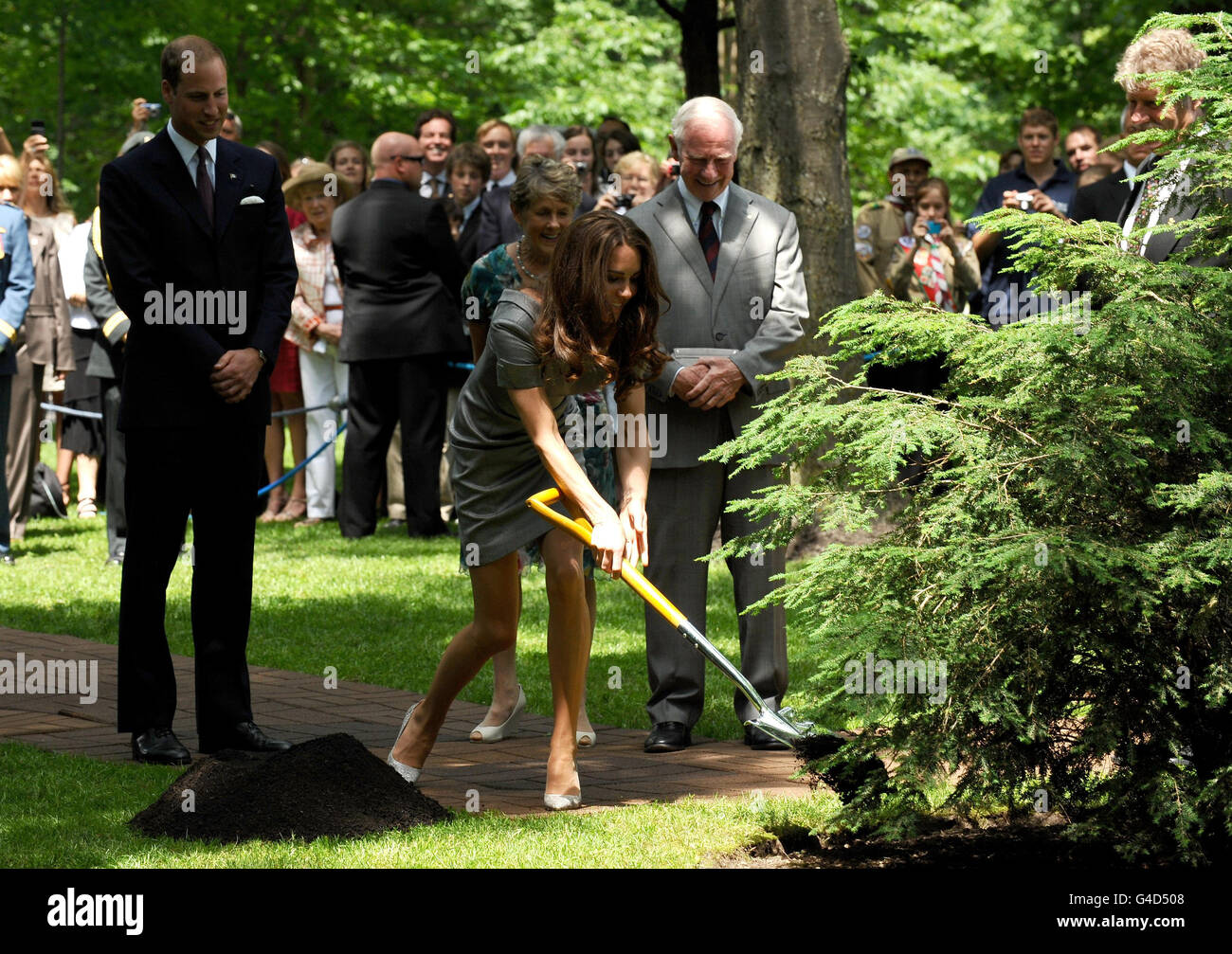 The Duchess of Cambridge shovels earth during a Tree Planting Ceremony ...