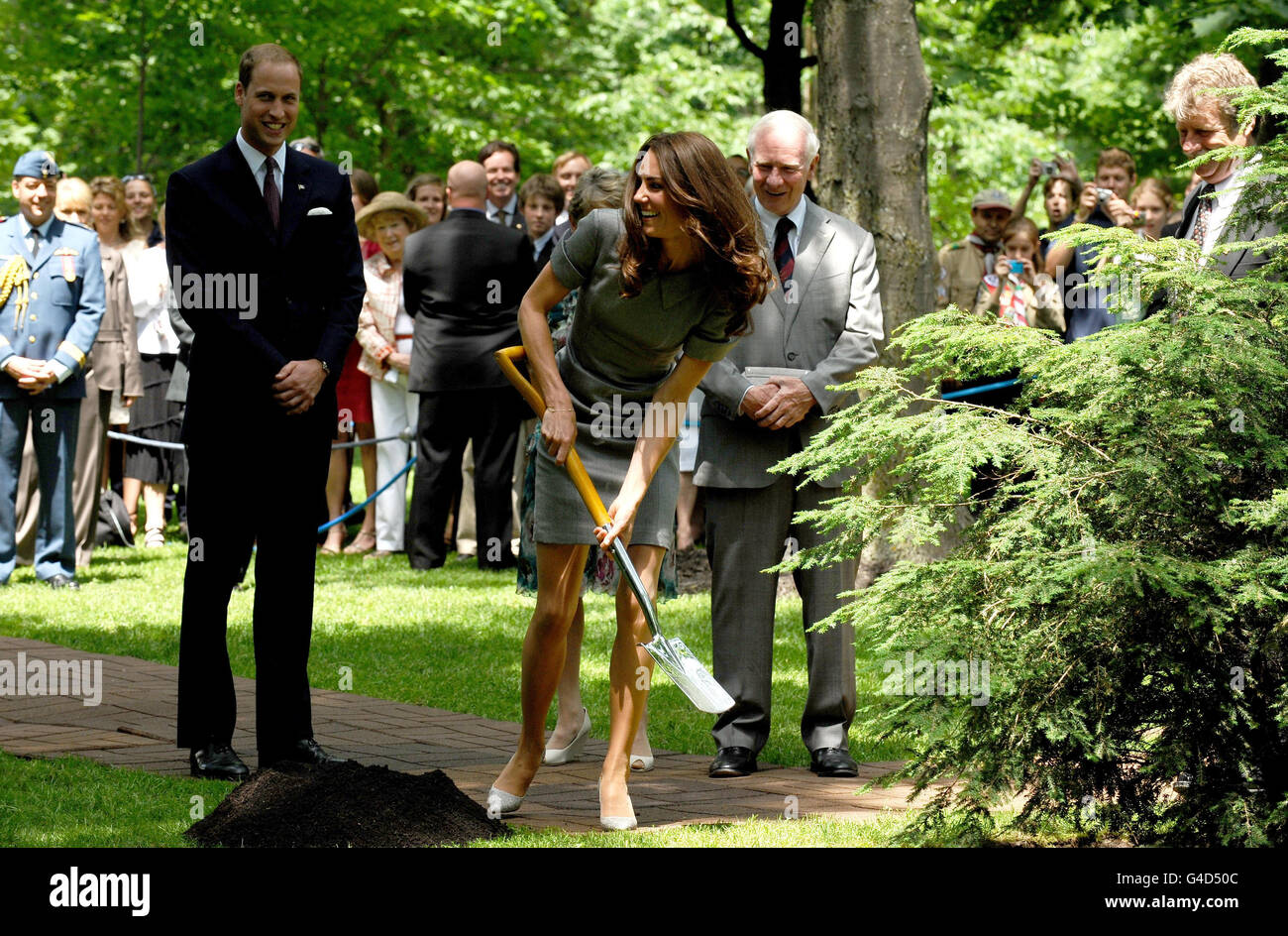 The Duchess of Cambridge shovels earth during a Tree Planting Ceremony ...