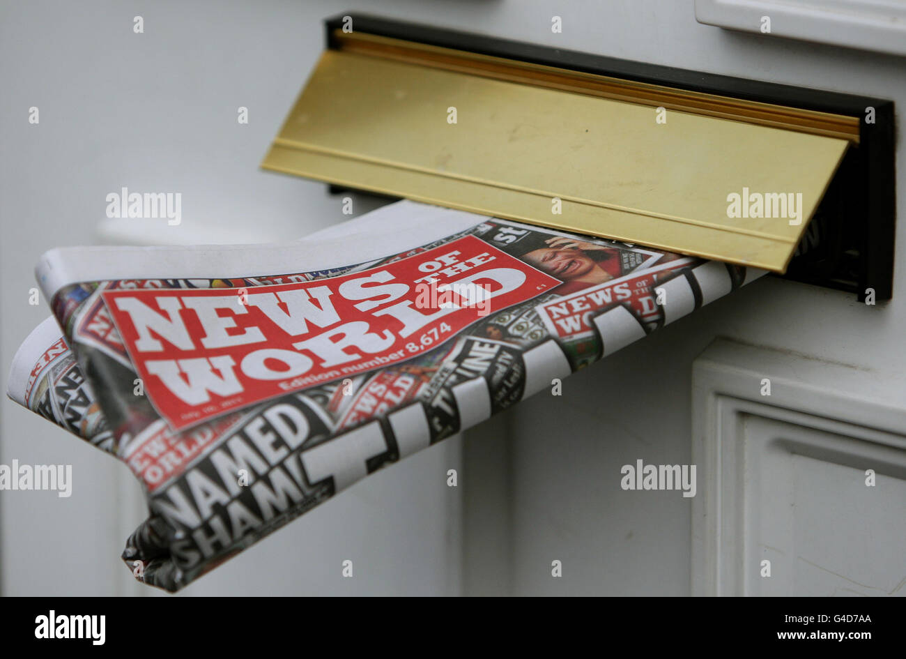 A final copy of the News of the World newspaper sticks out of a ...