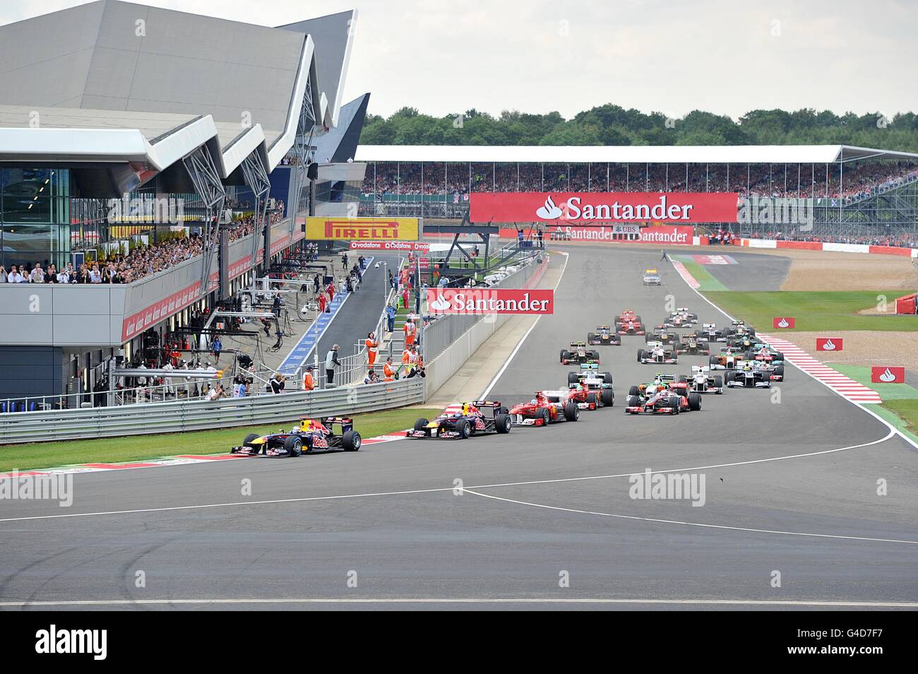 Red Bull Racing's Sebastian Vettel leads the field through the first ...