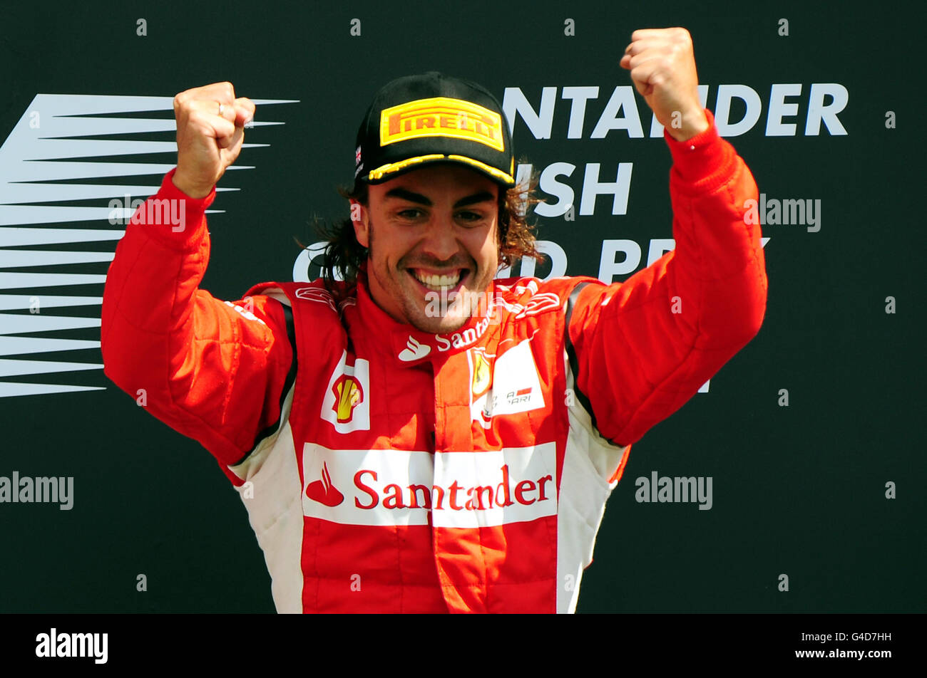 Ferrari's Fernando Alonso celebrates on the podium after winning during ...